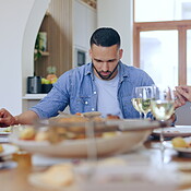 Big family, dinner and celebration in home with praying on food ...