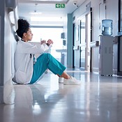 Hospital, woman and doctor on the floor, stress and burnout with ...