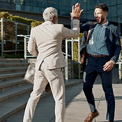 Business men, partnership and high five in city, teamwork and senior ...