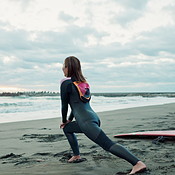 Surfer woman, stretching legs and beach with back, ready and workout ...