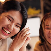 Japanese friends, laughing and talking in restaurant for dinner ...