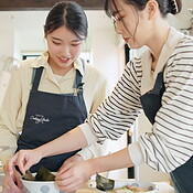Cooking class, students and plating japanese food in kitchen, happiness ...