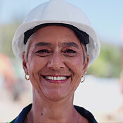 Woman, face and headshot, senior in construction outdoor, building site ...