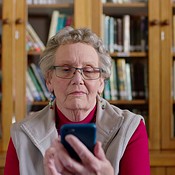 Serious woman, phone and senior lady typing message or chatting on ...