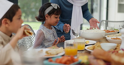 Muslim, family and children with food or dinner at dining table for eid ...