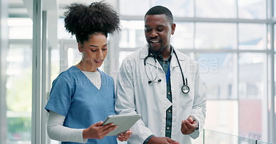 Doctor, nurses and reading on tablet for healthcare research, hospital planning and teamwork ...