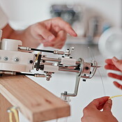 Needle, threading and yarn in tool in workshop, hands and art class ...
