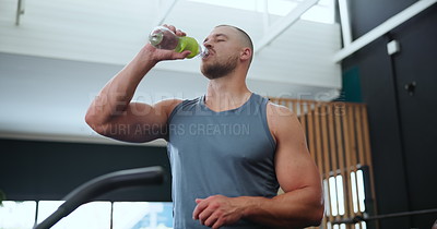 Exercise, health and hydration with man drinking water in gym for break ...