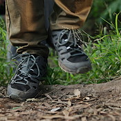 Walking stick, feet and man hiking in nature on trail for adventure ...