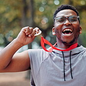 Black man, athlete and celebrate win with medal for success or goal ...