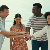 Diverse group, coworker and celebration at beach for team building with ...