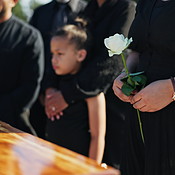 Coffin, family and child at graveyard for funeral, memorial service of ...