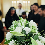 Funeral, death and people at coffin with flowers at memorial service at ...