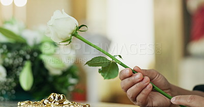 Grief, hand and person at coffin with rose at memorial service at ...