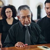 Funeral, coffin and sad man at church for death and grief with people ...