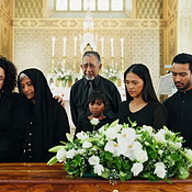 Funeral, family and child crying at coffin with flowers at memorial ...