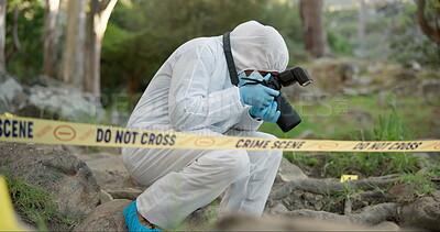 Forensic, photographer and police tape at crime scene for investigation in forest with evidence ...