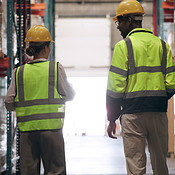 Logistics, man and woman in warehouse talking, walking and planning ...