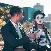 Businessmen, phone call and cellphone with street mime in downtown New ...
