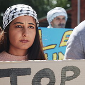 War, protest and sign to stop with woman in city for justice and crowd ...