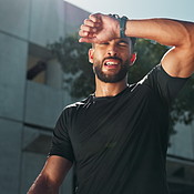 City, tired and man with fitness, sweating and exhausted with workout ...