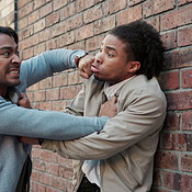 Angry man, thief and punching face with fist on wall for fight, beat or ...