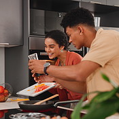 Cooking, influencer and couple in kitchen with camera for live ...