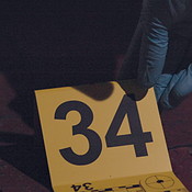 Person, hands and crime scene with number for evidence, investigation ...