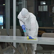 Spray, disinfect and person with hazmat suit in laboratory for germs ...