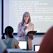 Female lecturer, coding and screen in class for education with html, teaching with technology ...