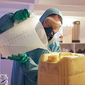 Experiment, ppe and person with liquid in lab for research, chemistry ...