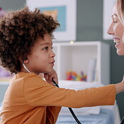 Doctor, child and stethoscope with playing in hospital for examination ...