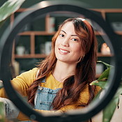 Woman, influencer and face in home with plants for botanical tips or ...
