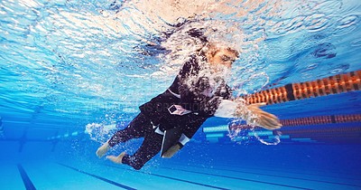 Business, man and working on laptop in pool, typing and drowning in ...