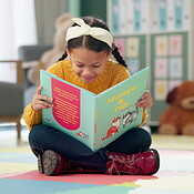 Girl, school and reading book in classroom, childhood development and ...