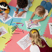 Kindergarten, art and children drawing on classroom floor for color ...