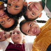 Children, face and outdoor huddle with smile from below for school trip ...