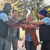 Volunteers, teamwork and hands stack in outdoors, motivation and care ...