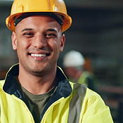 Proud, worker and helmet of man in construction, safety and industry of ...