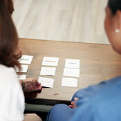 Nurse, senior woman and exercise in Alzheimers with paper for memory ...