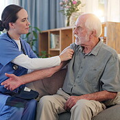 Nurse, couch and blood pressure of senior man for patient assessment ...