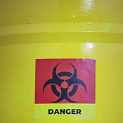 Toxic, bin and container in laboratory with danger sign for ...