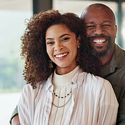 Couple, face and happiness in new home with hug for property ...