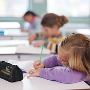 Student, writing and classroom for education at school with learning ...
