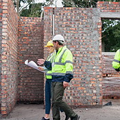 Engineering, teamwork and people at construction site with floor plan ...