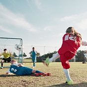 Football, player and children in stadium for shooting, practice and ...
