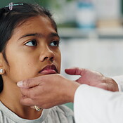 Doctor, kid and hands touching neck to check for tonsils, thyroid ...