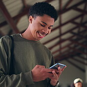 Boy, texting and smile on smartphone in high school, communication and ...