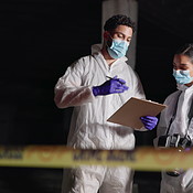 Crime scene, forensic man and woman in discussion with evidence, ppe ...