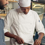 Kitchen, culinary students and chef with knife for teaching, skills ...